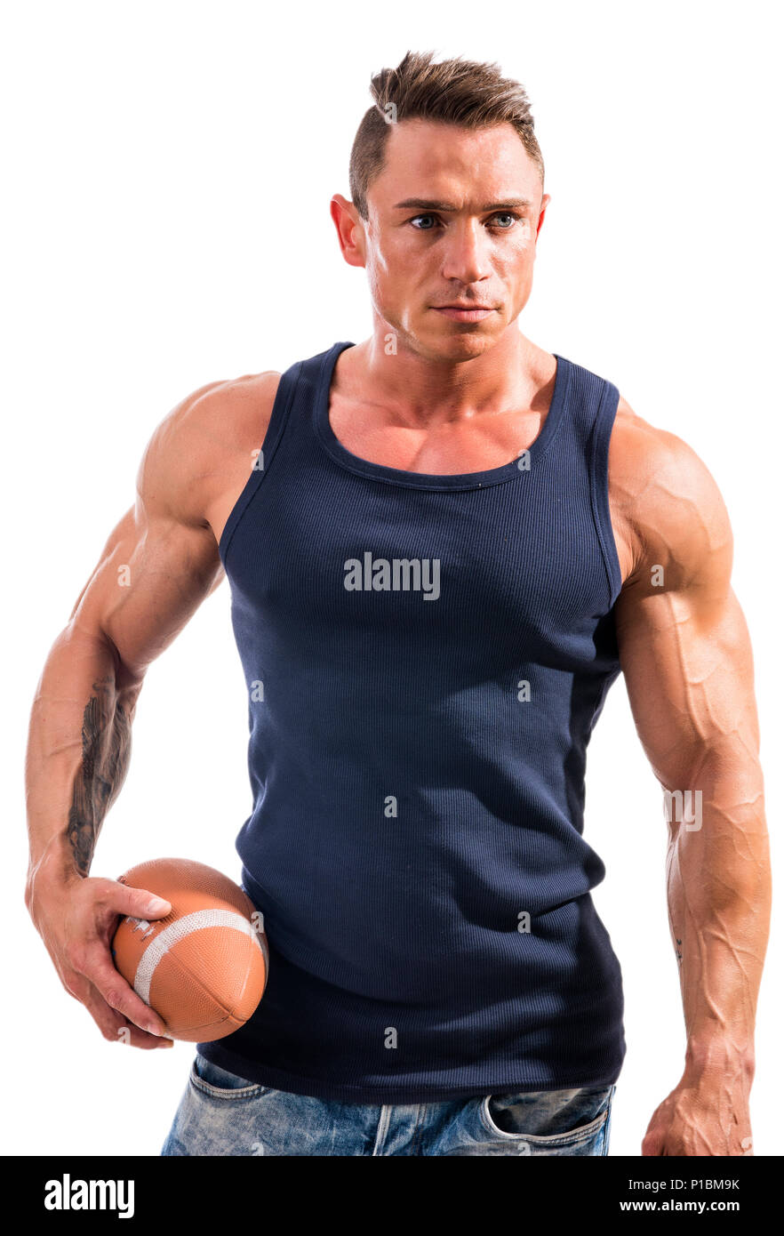 Muscular man holding football or rugby ball Stock Photo - Alamy
