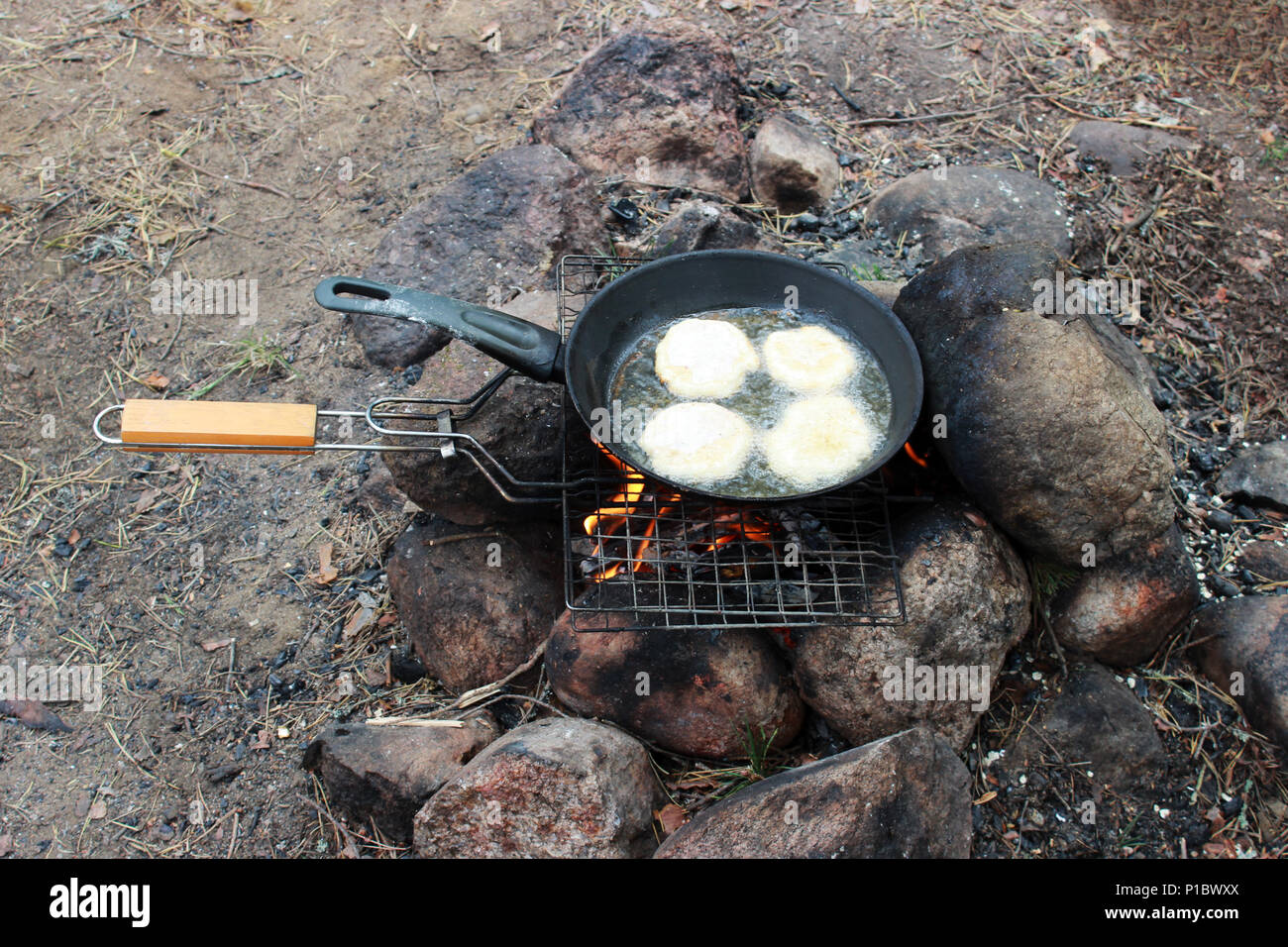 pancakes, cooked in a frying pan on an open fire in a hike in the ...