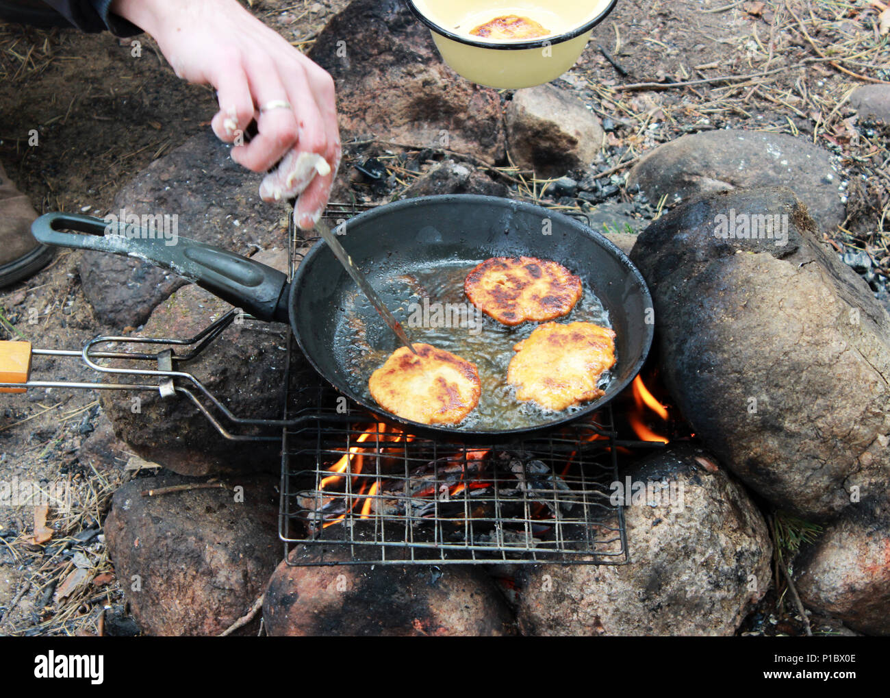 pancakes, cooked in a frying pan on an open fire in a hike in the ...
