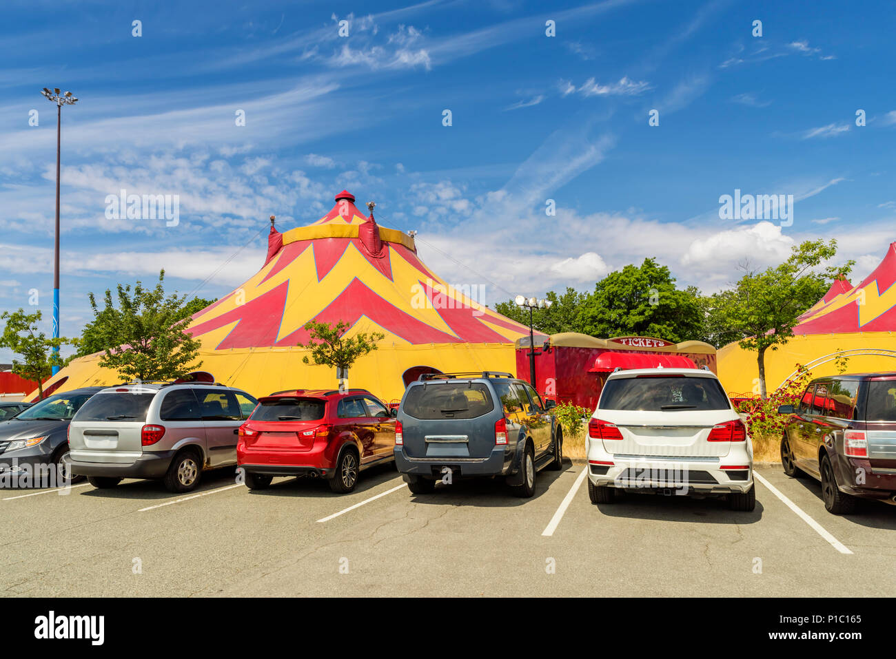 Mobile circus in a car park in the city, among cars on a summer day, a ...
