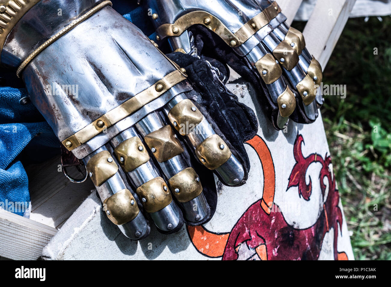 Medieval knight metal hand gloves on shield. Traditional knights ...