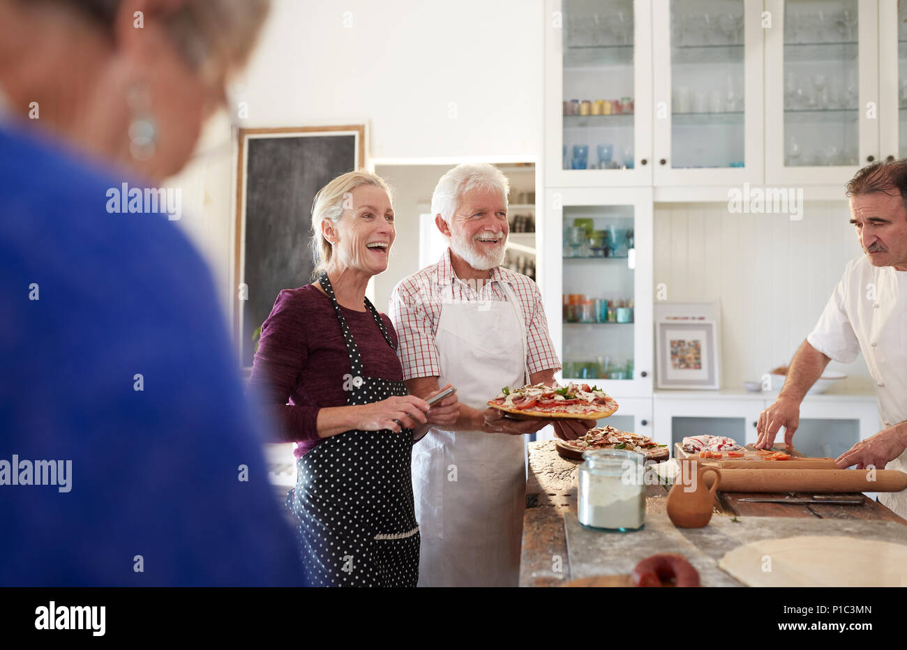 Senior couple making pizza in cooking class Stock Photo - Alamy