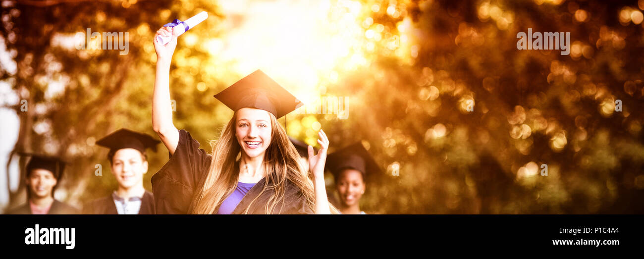 Graduate school kids standing with degree scroll in campus Stock Photo ...