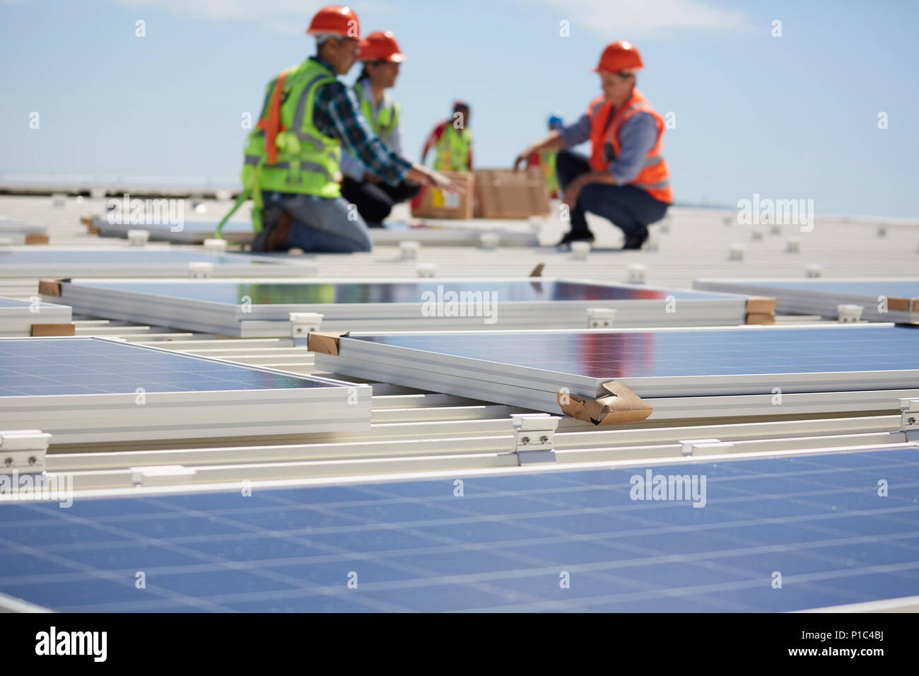 Engineers installing solar panels at sunny power plant Stock Photo - Alamy