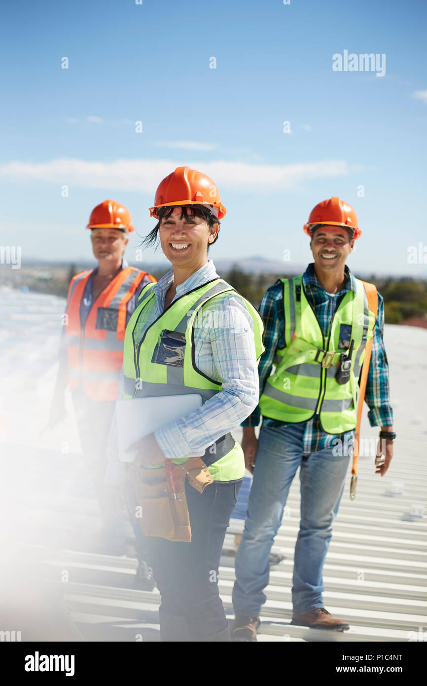 Portrait smiling, confident engineers at sunny power plant Stock Photo ...