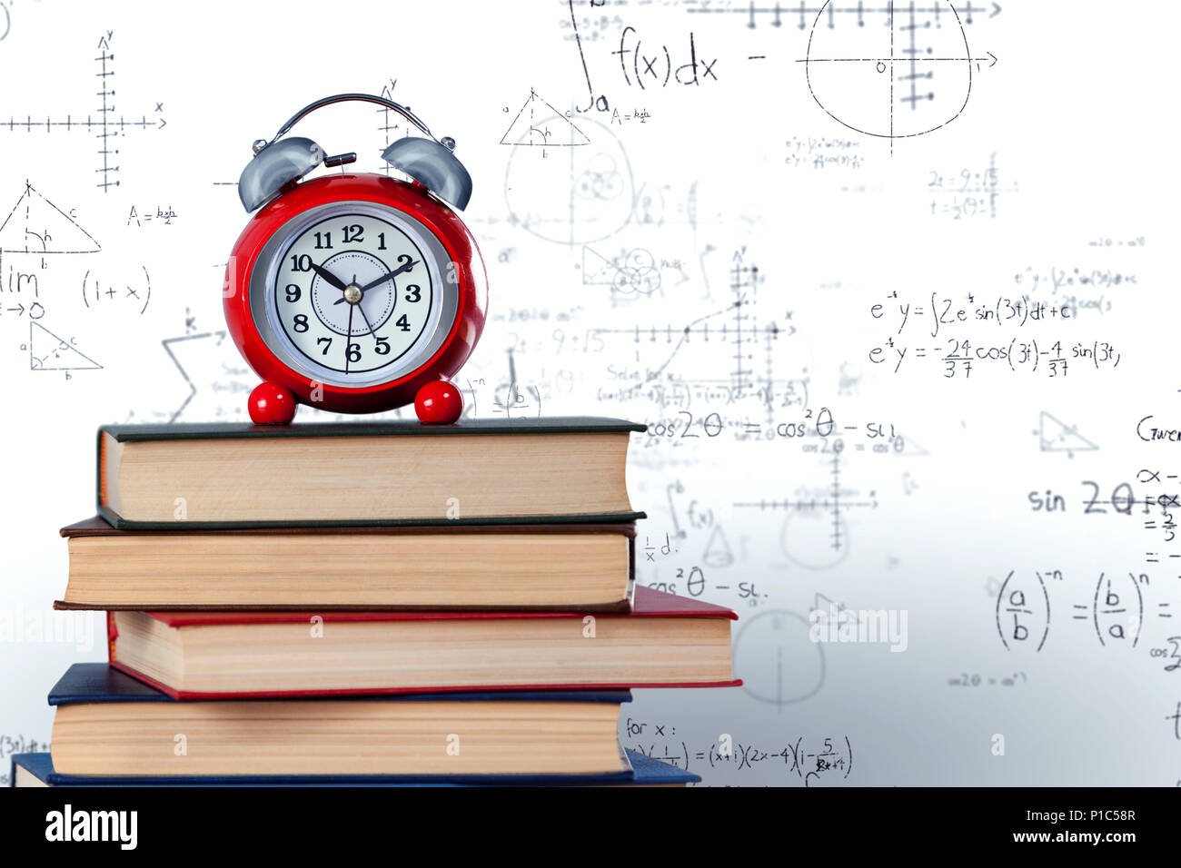 Old alarm clock and stack of books Stock Photo - Alamy