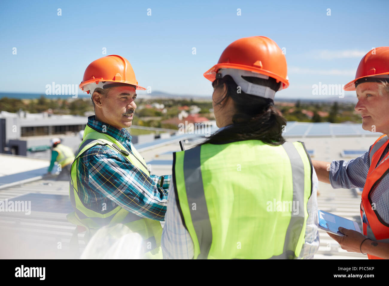 Workers talking at solar power plant Stock Photo - Alamy