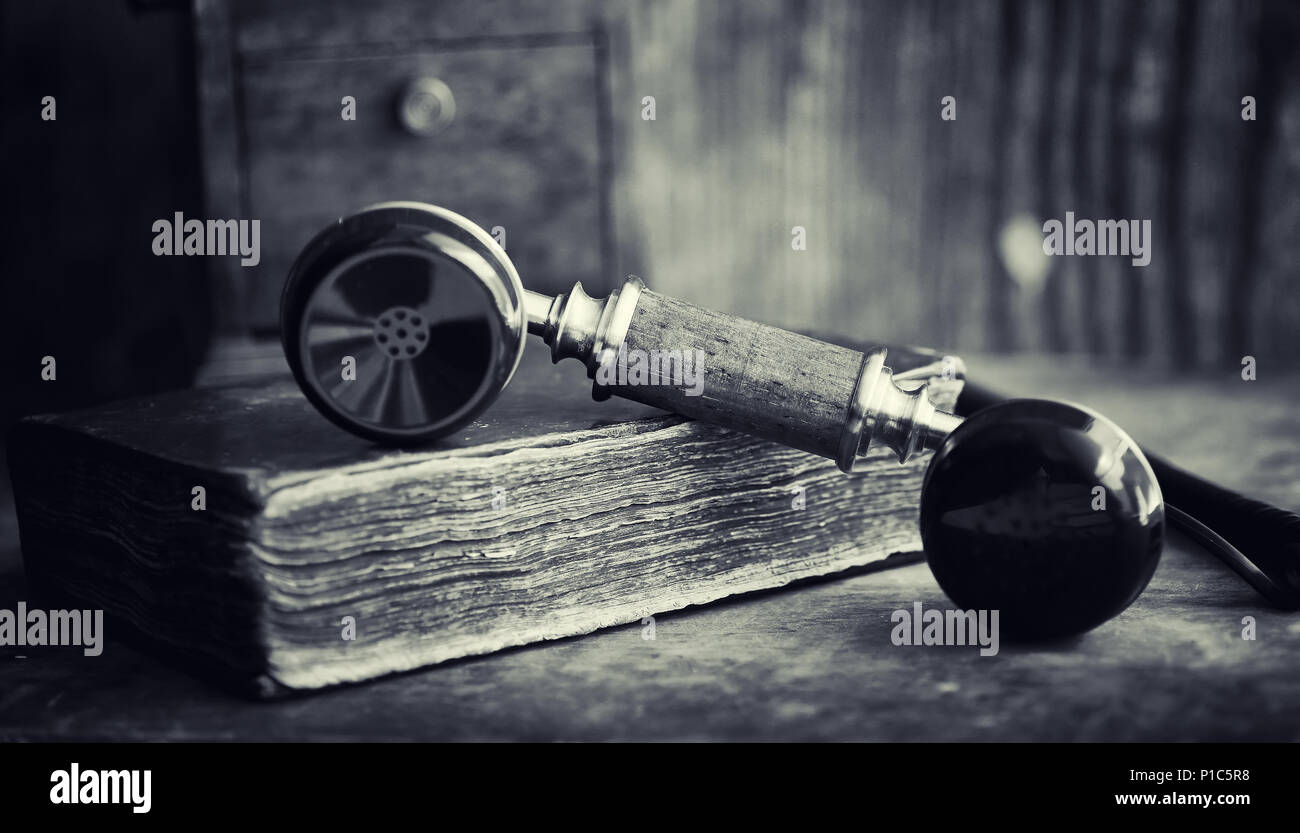 Old telephone and retro book on the desk. The phone of the past Stock ...