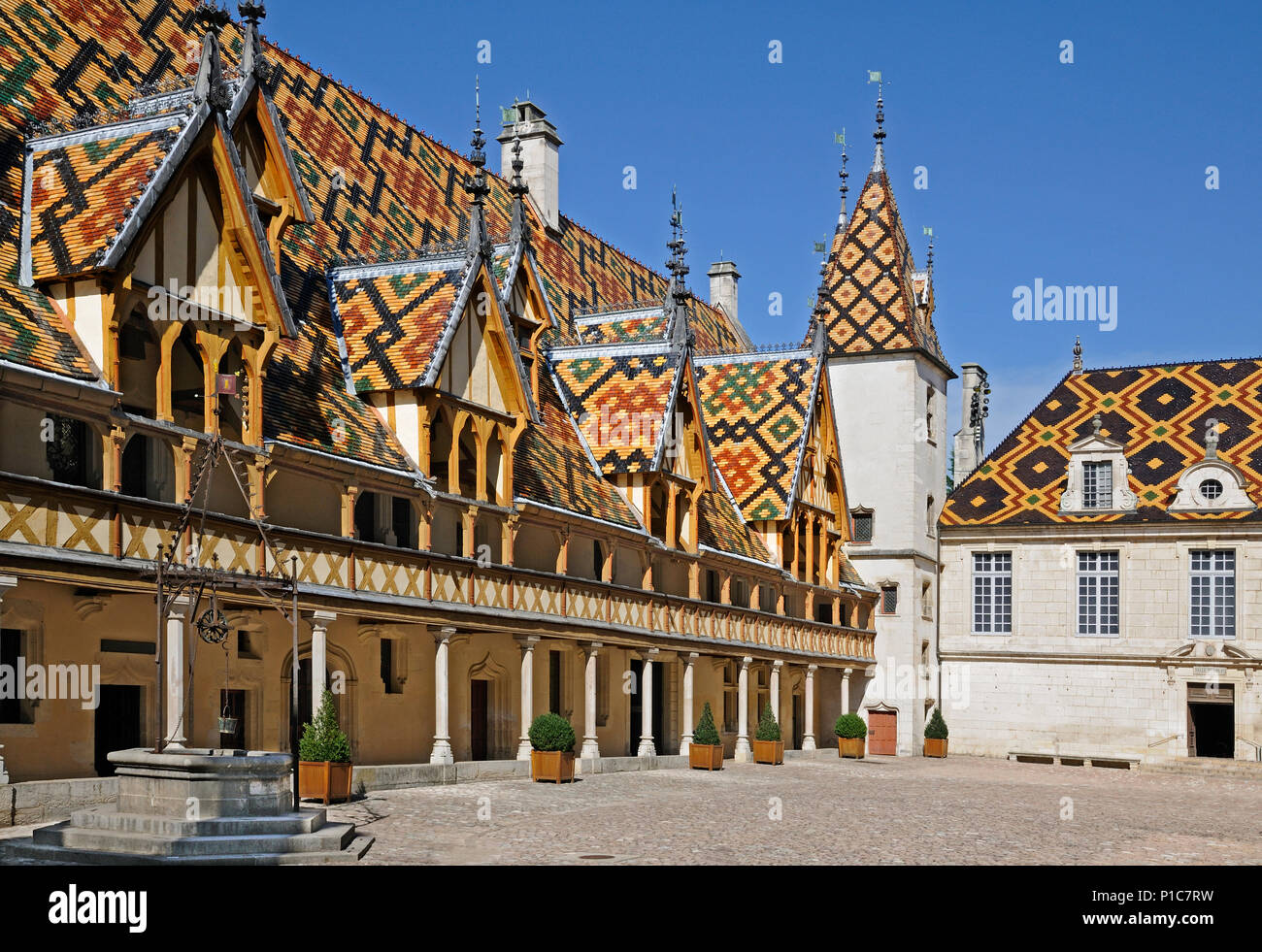 Courtyard of "Hotel Dieu" with glazed tile dormer windows weather vanes ...