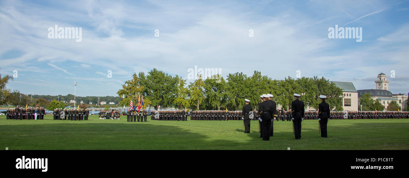 Midshipmen with the U.S. Naval Academy (USNA) stand at the position of ...
