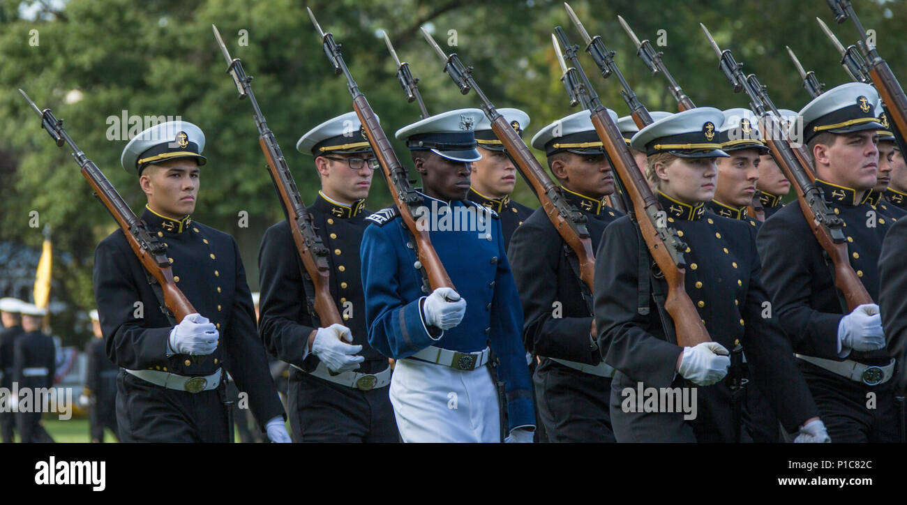 Midshipmen with the U.S. Naval Academy (USNA) pass in review during the ...