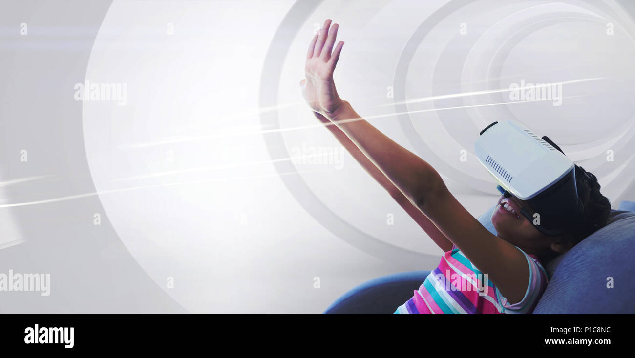 Girl wearing virtual reality simulator on couch Stock Photo - Alamy