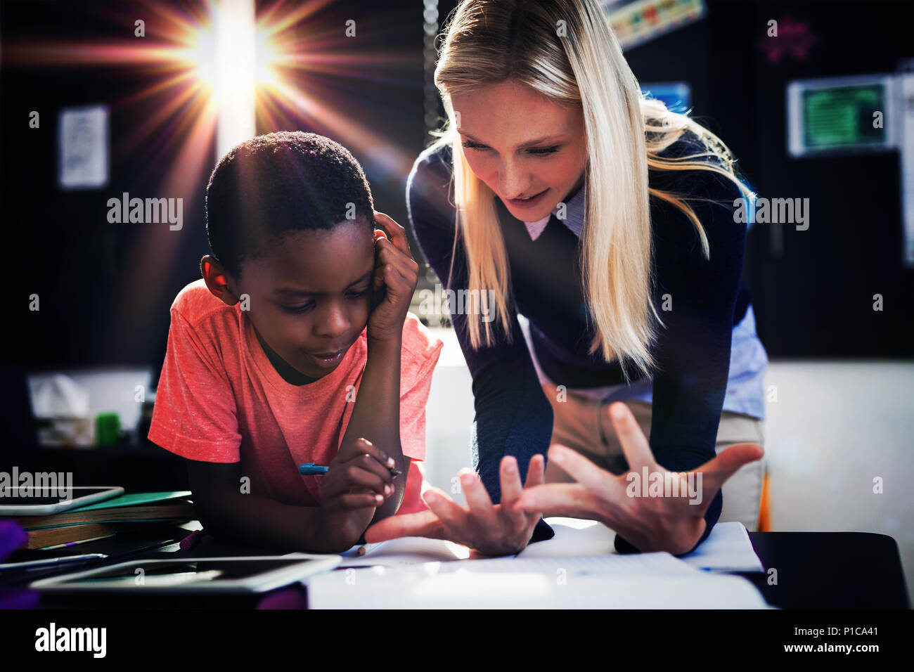 Male teacher helping student hi-res stock photography and images - Alamy