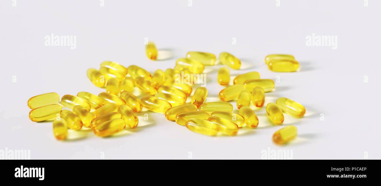 Medical medicines and supplements transparent capsules of yellow color ...