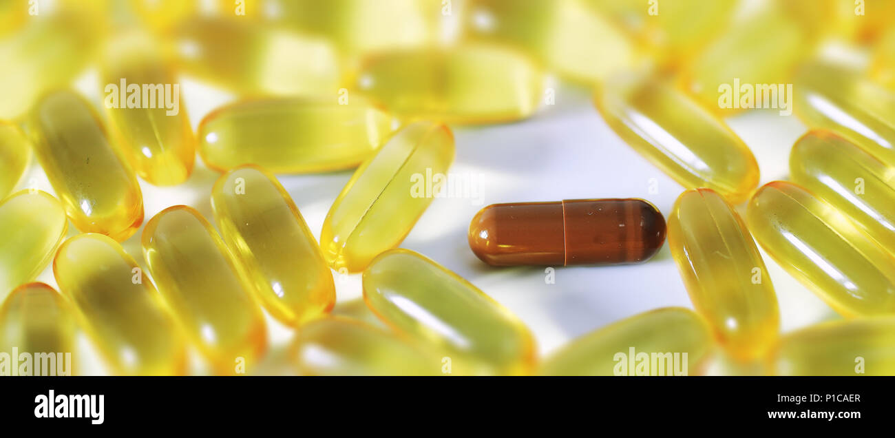 Medical medicines and supplements transparent capsules of yellow color ...