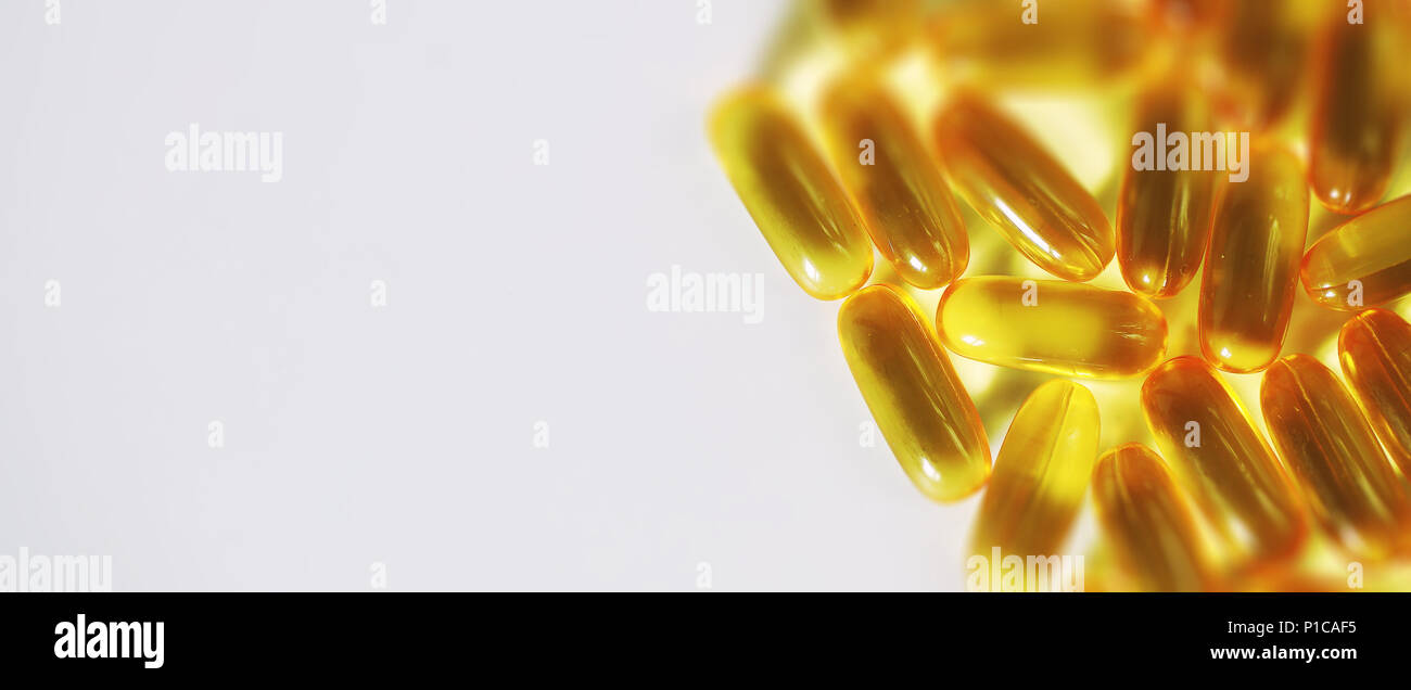 Medical medicines and supplements transparent capsules of yellow color ...