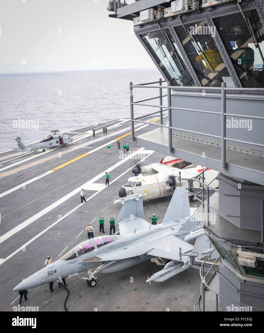 Sailors and Marines conduct flight operations on the flight deck of ...