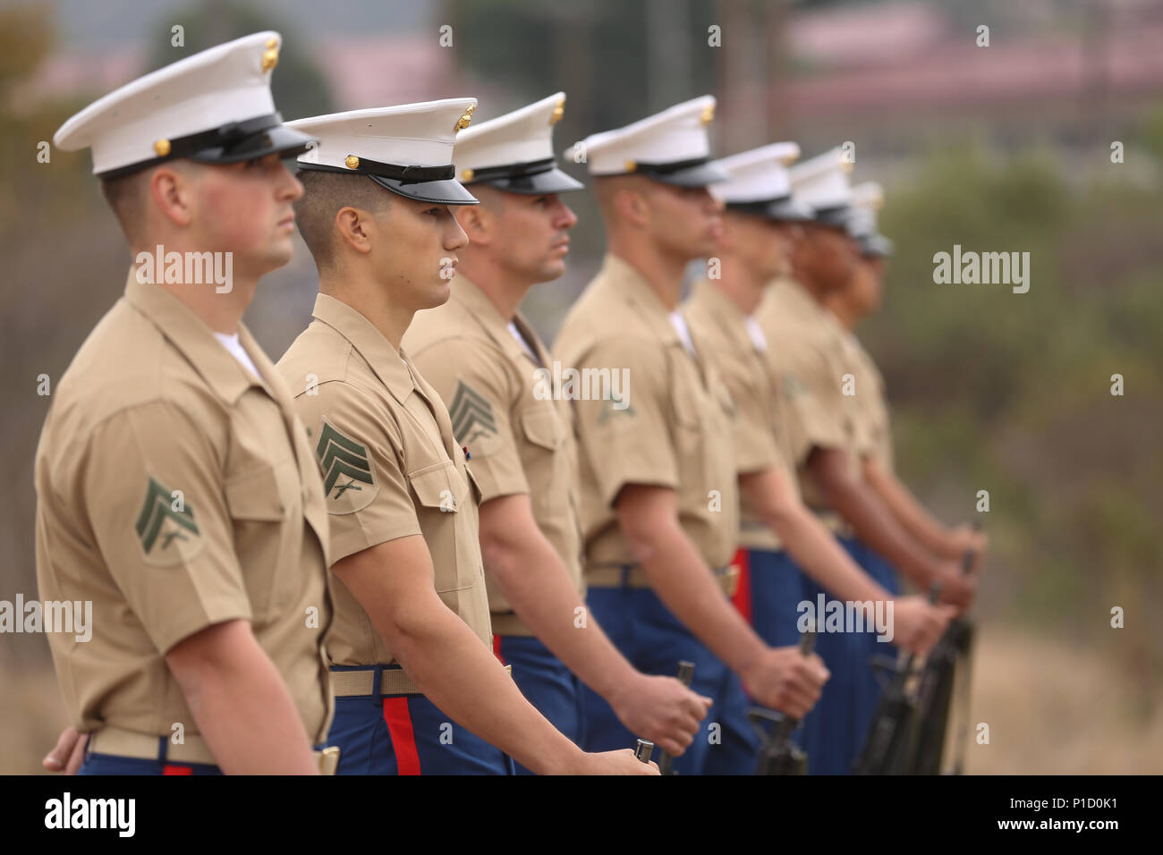 A Marine rifle detail stands at parade rest prior to a memorial service ...