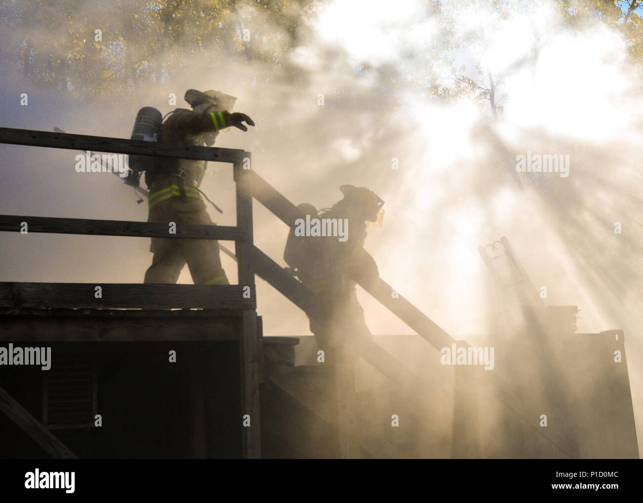 Airmen of the 174th Attack Wing Fire Department exit a simulated ...