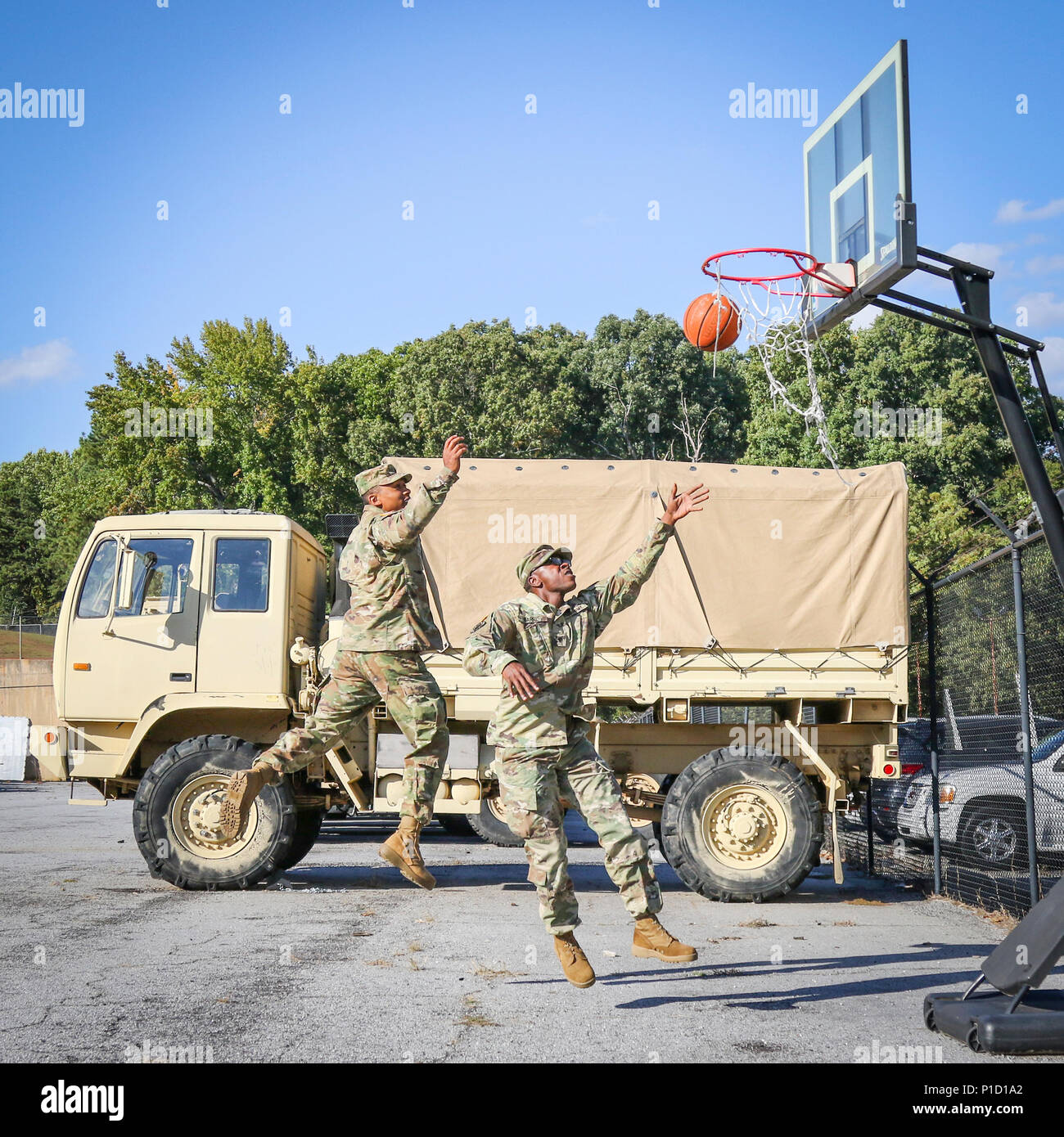 Two soldiers with the 335th Signal Command (Theater) play some hoops in ...