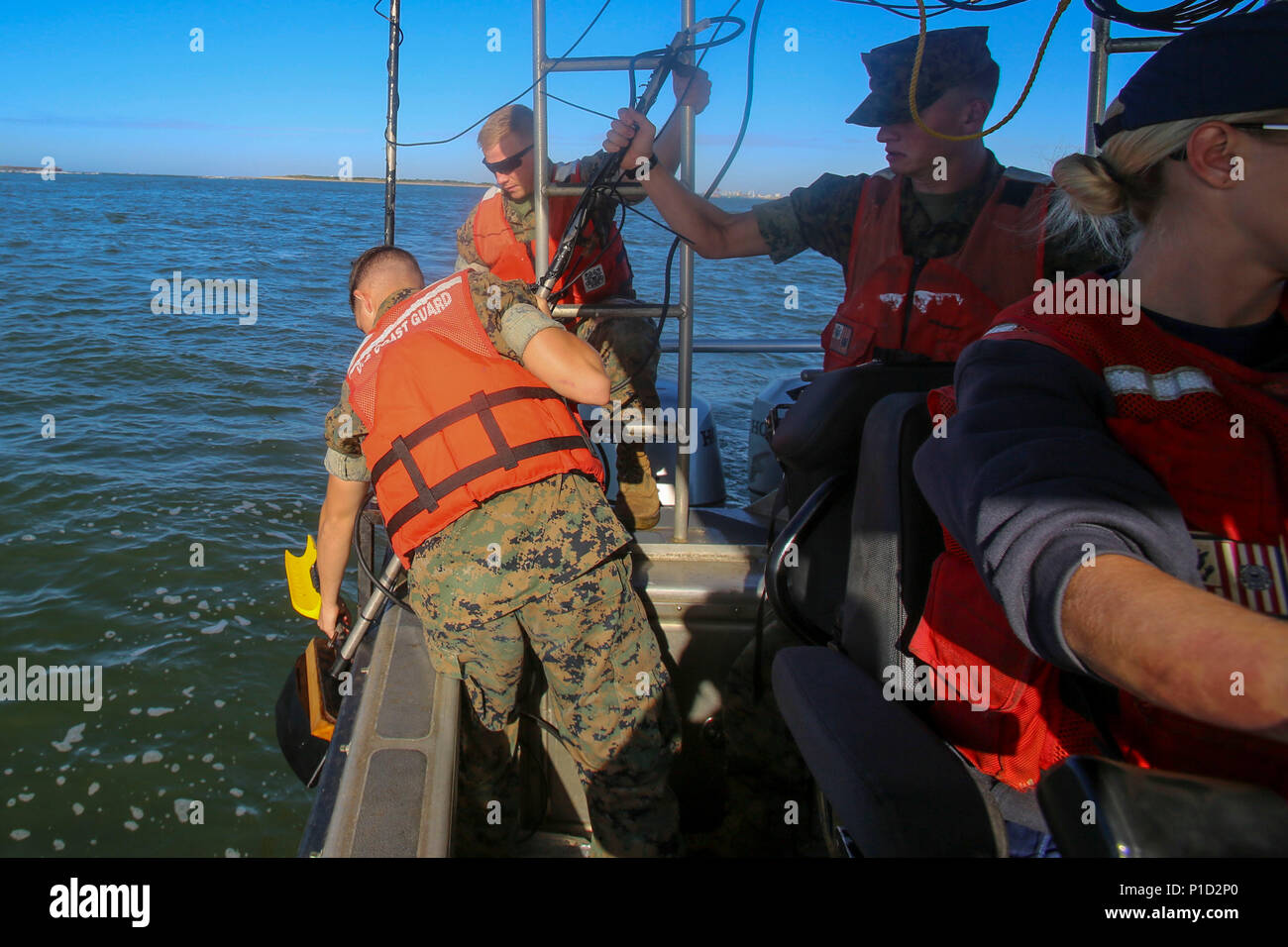 Lance Cpl. Kyle Combass places the StarFish side scan SONAR in the ...