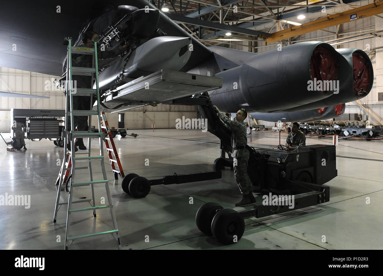 Airmen from the 5th Aircraft Maintenance Squadron use a MHU-83 Jammer ...