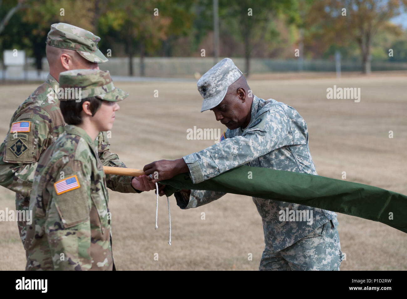 1st Sgt. Donald Richey casing the colors of the 1343rd CBRN Co., also ...