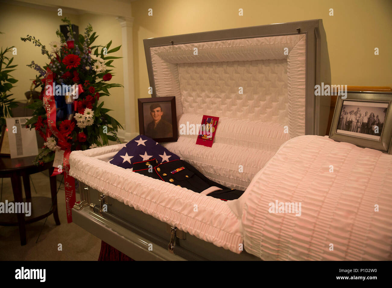 A casket holds the physical remains, uniform, and photo of Pfc. James Samuel Smith during a ...
