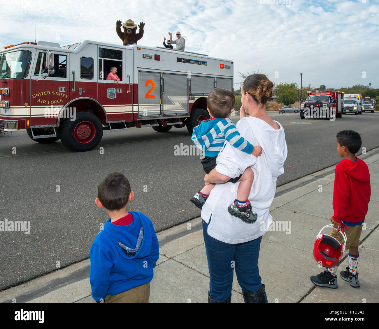 Military family housing residents wave at the 60th Civil Engineer ...