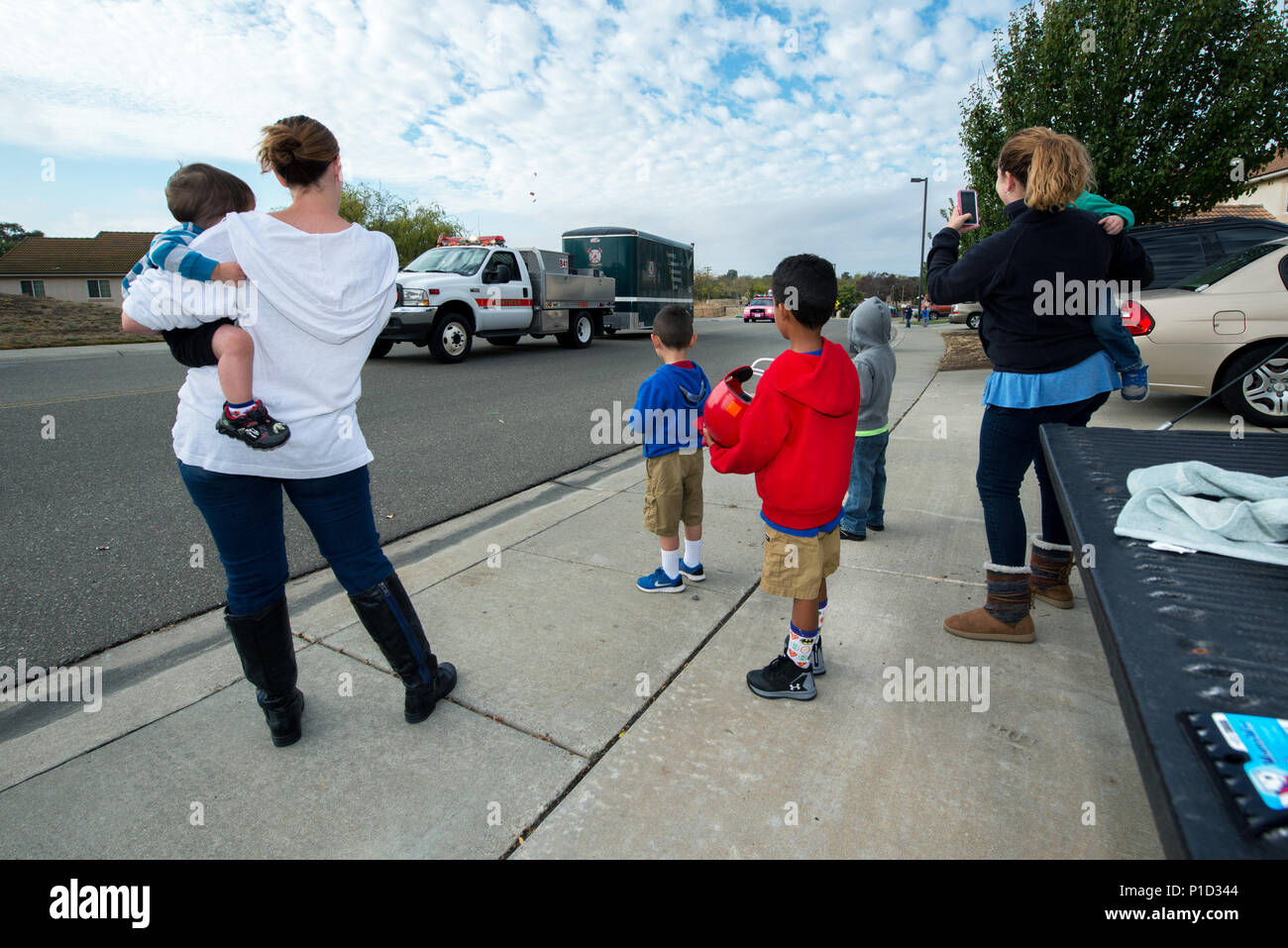 Military family housing residents wave at the 60th Civil Engineer ...