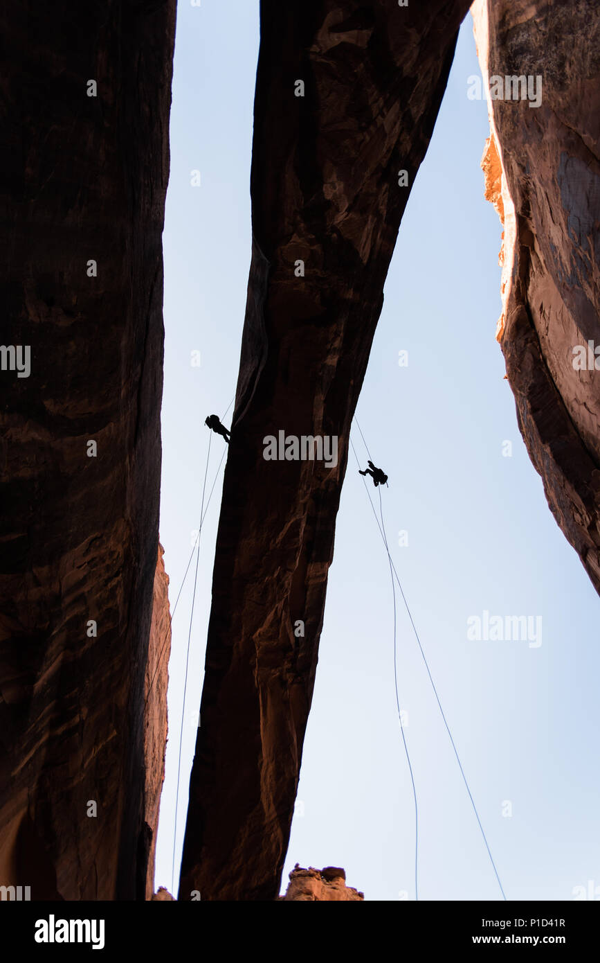 People rappelling from an arch in Moab, Utah Stock Photo - Alamy