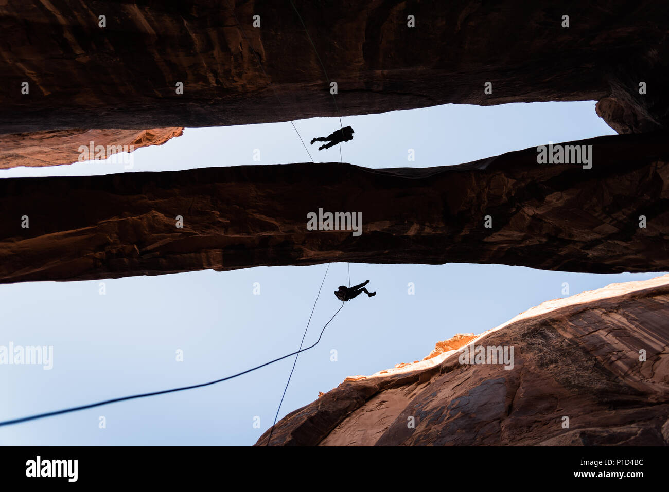 People rappelling from an arch in Moab, Utah Stock Photo - Alamy