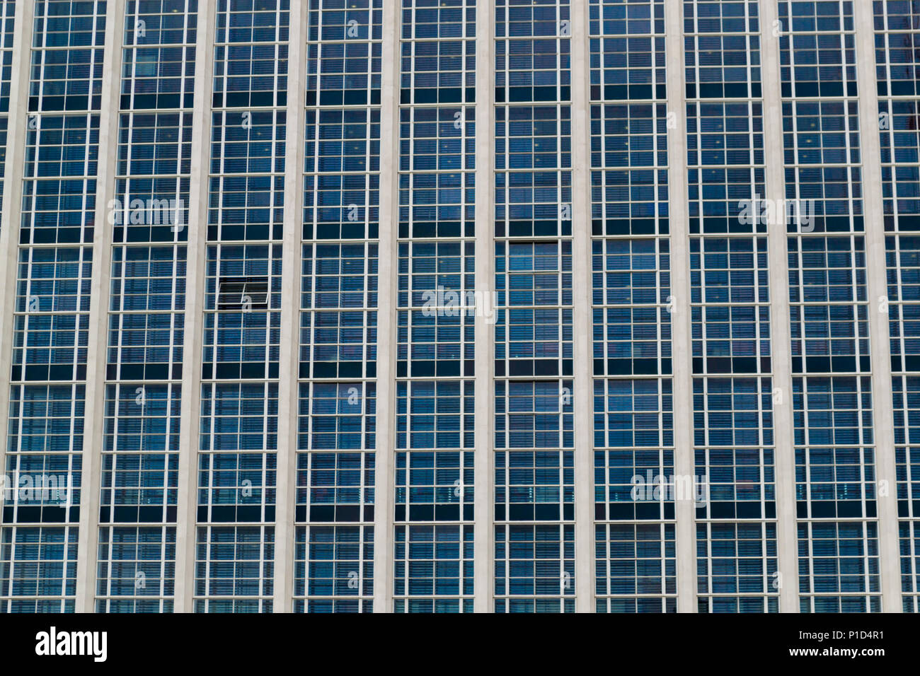 A single open window in an office block covered in windows Stock Photo ...