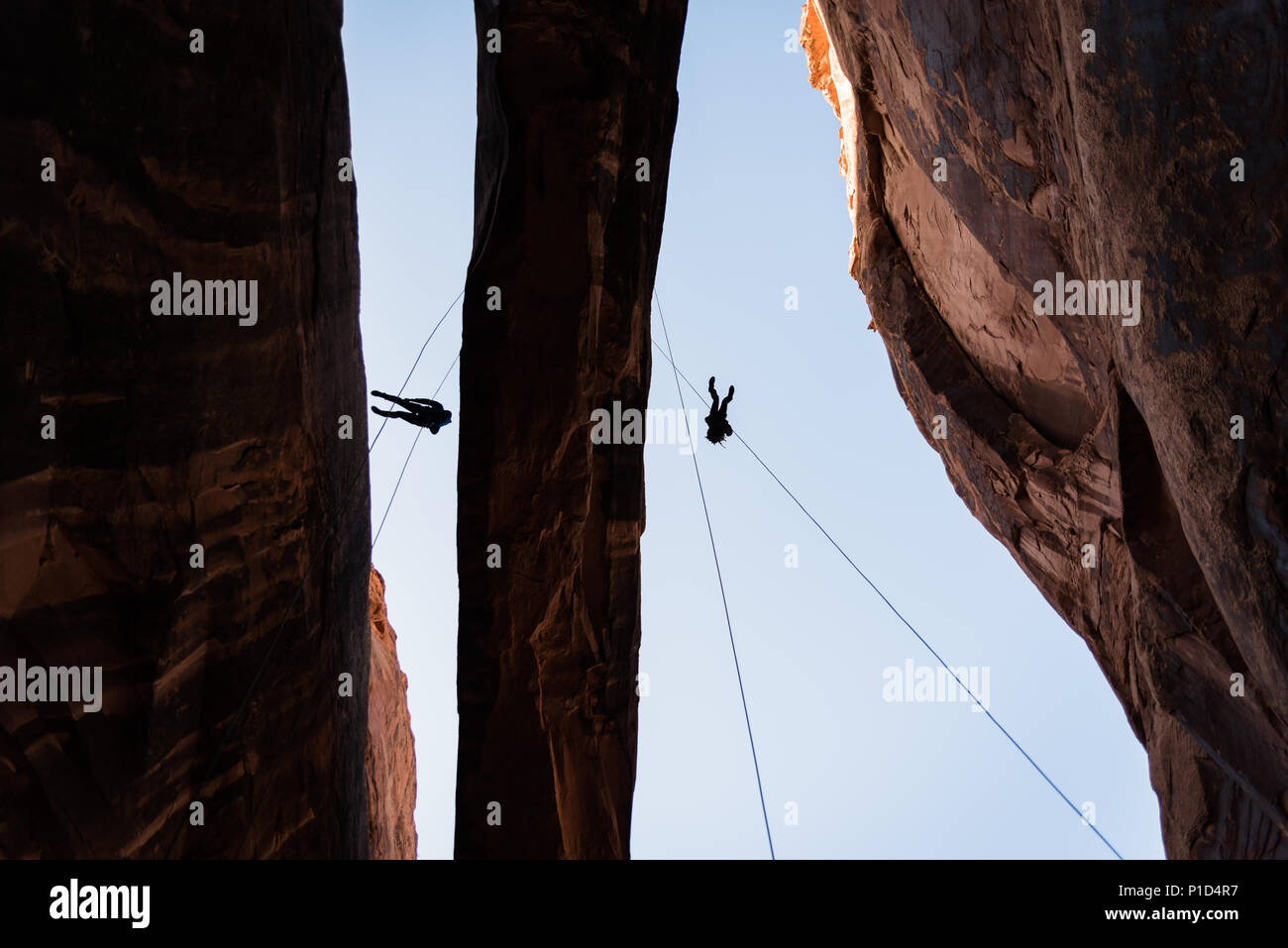 People rappelling from an arch in Moab, Utah Stock Photo - Alamy