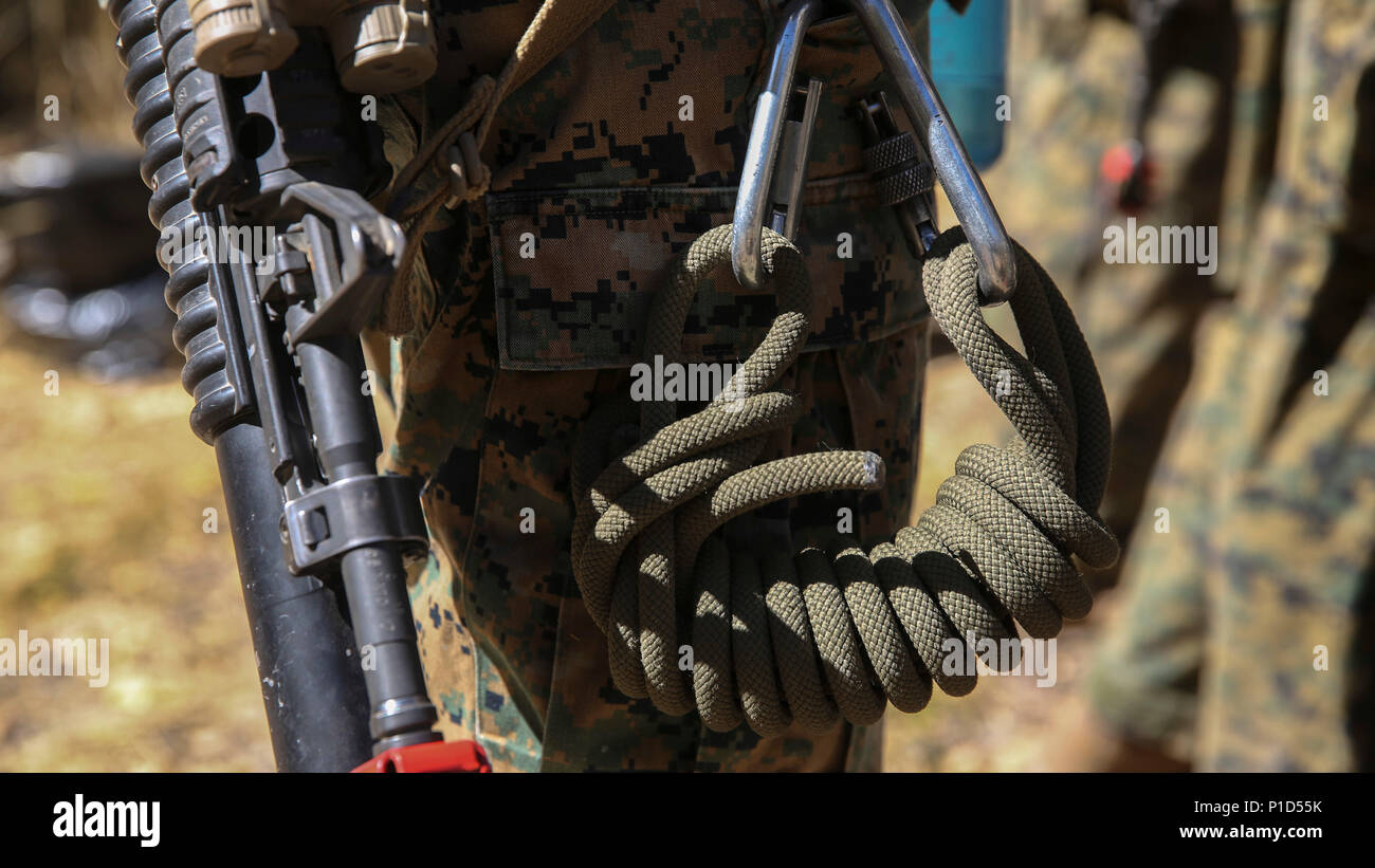 Marines of 3rd Battalion, 4th Marine Regiment, carry sling rope along ...