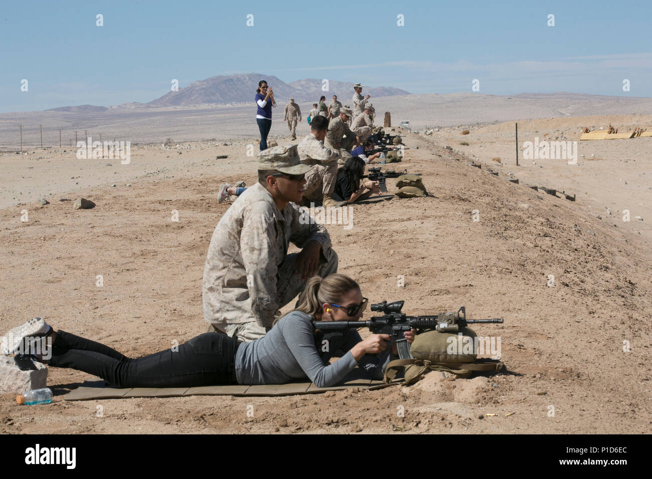 Spouses of 1st Battalion, 7th Marine Regiment Marines, shoot M4 rifles ...