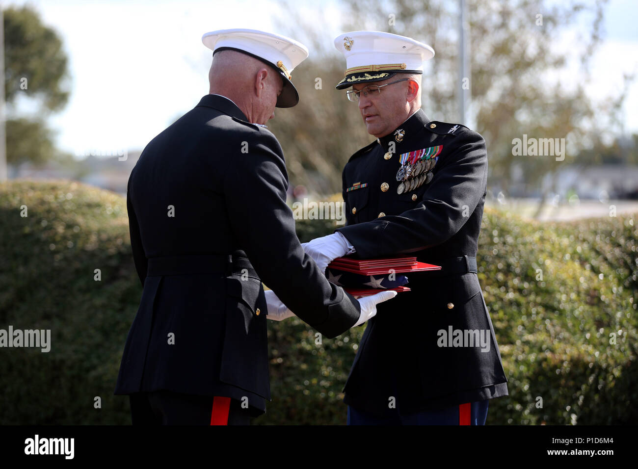 Retired Maj. Gen. Charles L. Hudson presents Col. Yori R. Escalante a ...