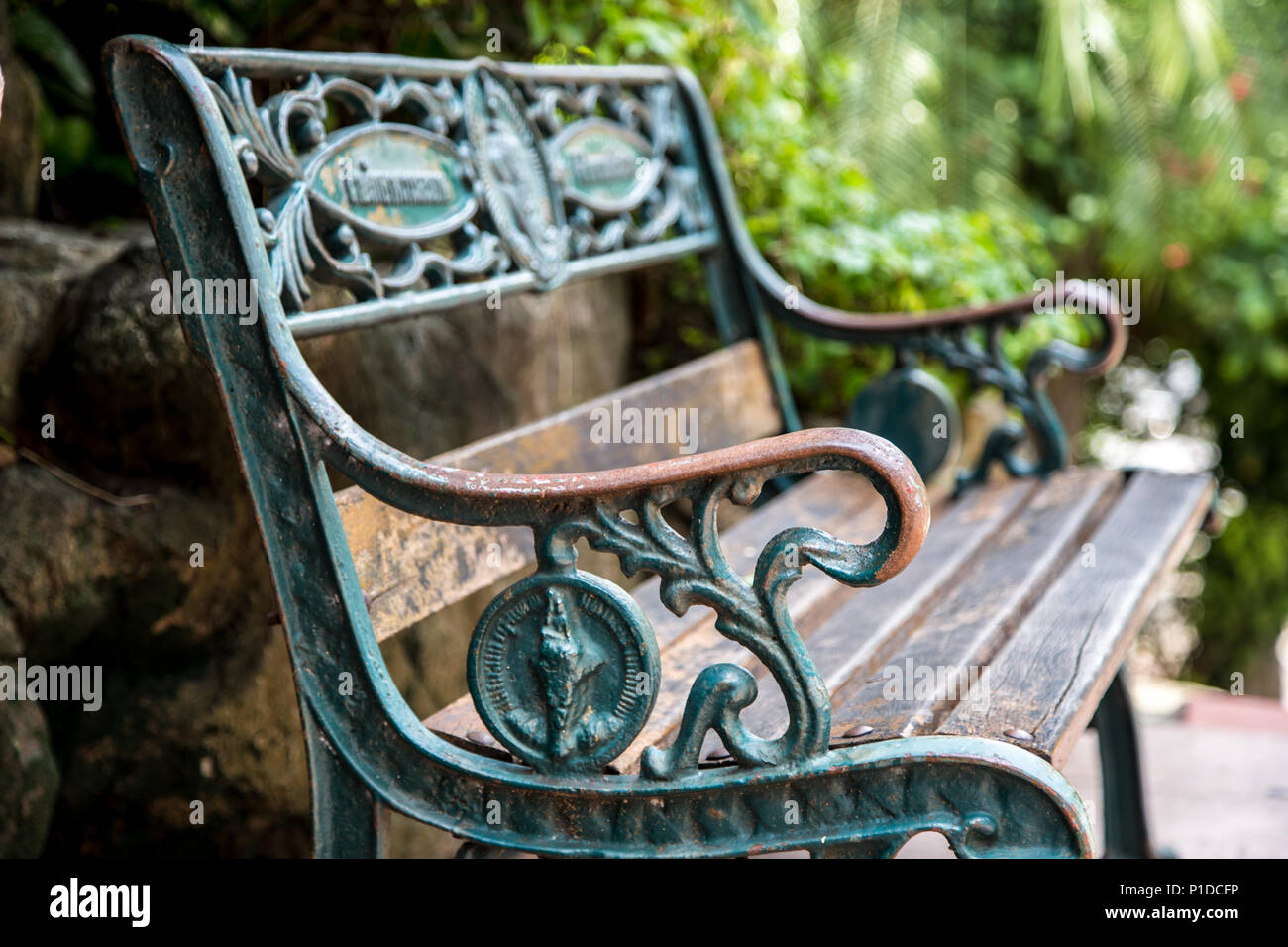 beautiful retro bench with wrought-iron lace handles Stock Photo - Alamy