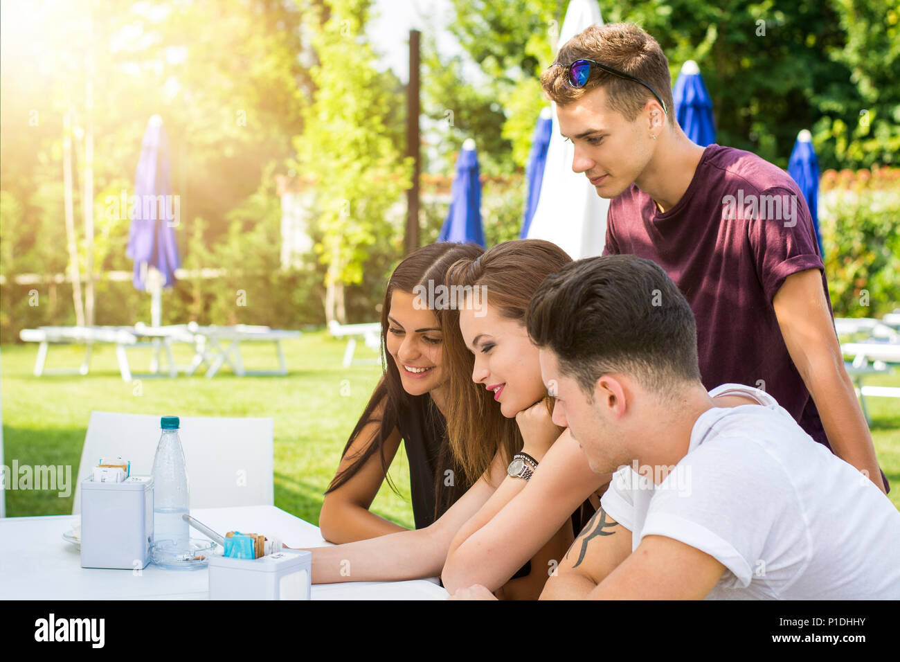 Young people having fun watching hi-res stock photography and images ...