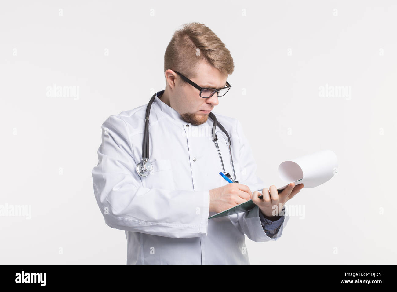 Medical doctor writing prescription over white background Stock Photo ...