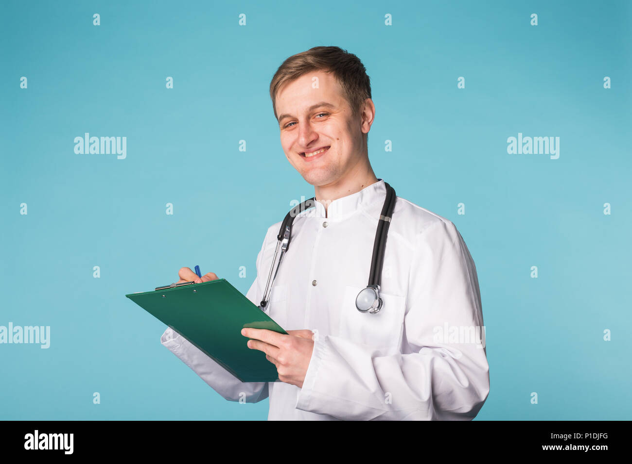 Medical doctor writing prescription over blue background Stock Photo ...