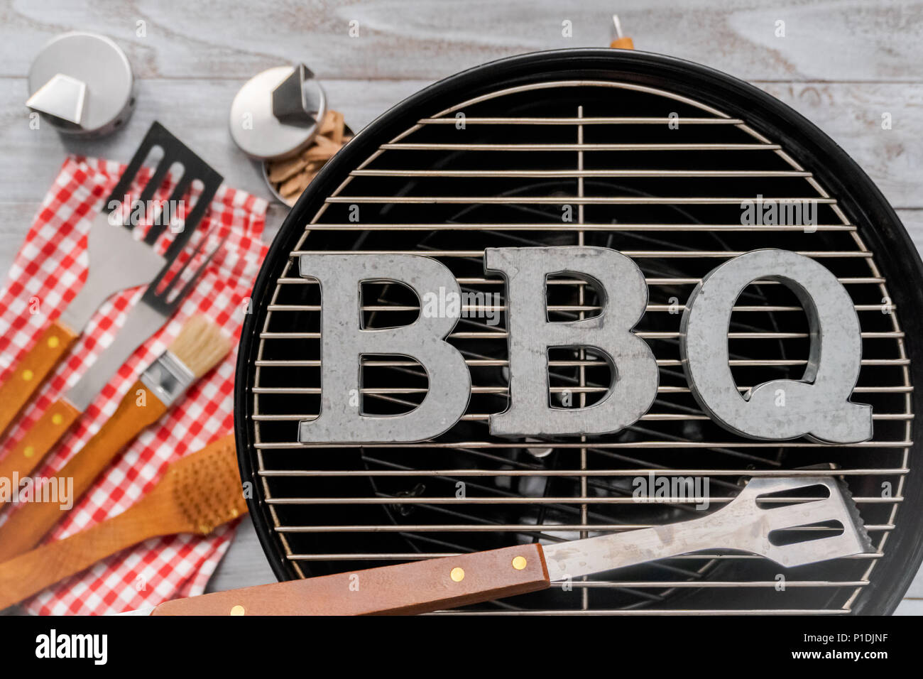Metal BBQ sign with BBQ cooking tools on a wood background Stock Photo ...