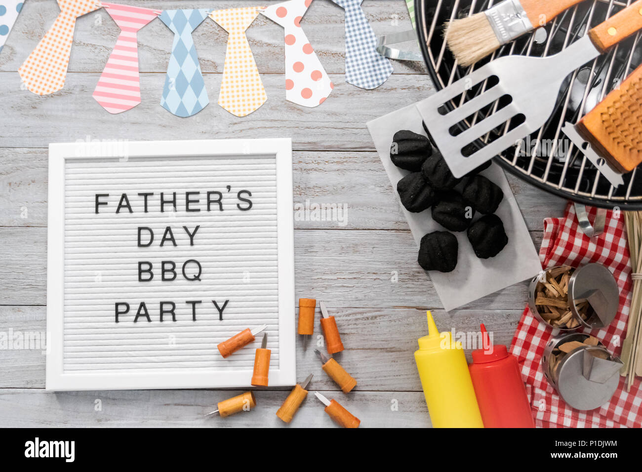 Father's Day BBQ Party sign on a white memo board with cooking tools ...