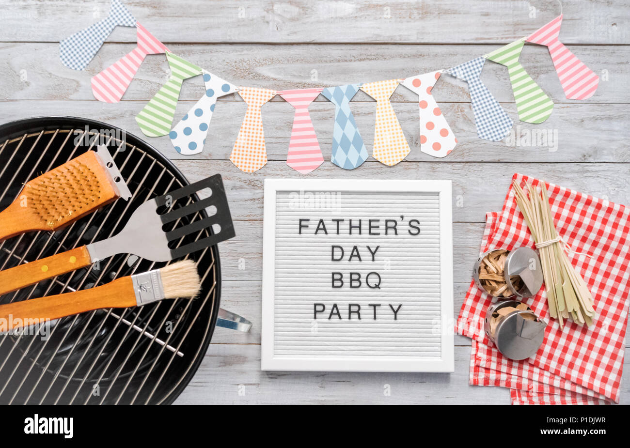 Father's Day BBQ Party sign on a white memo board with cooking tools ...