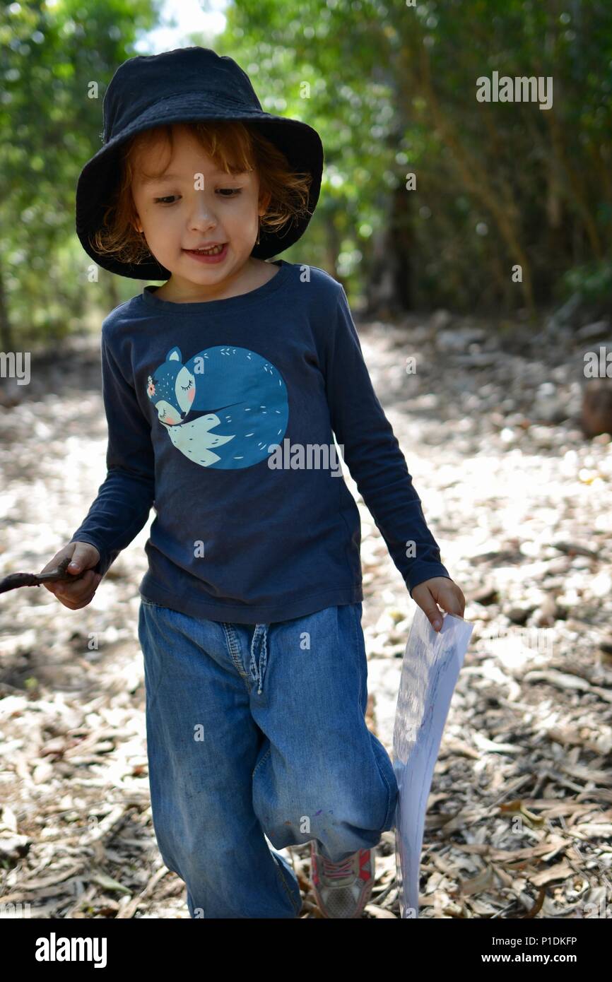 Young girl walks with a map on a track through a forest, Paluma Range ...
