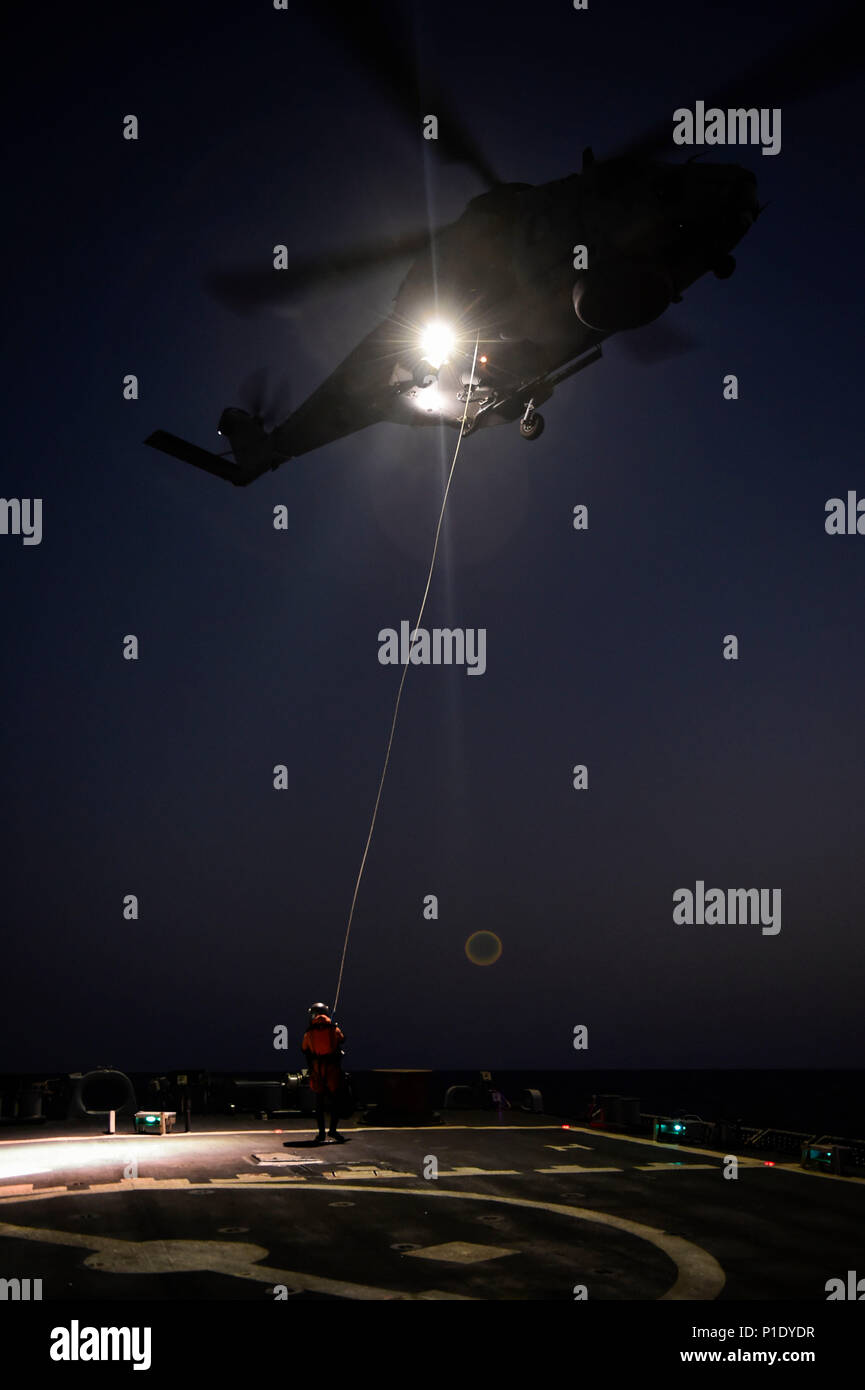 161014-N-FP878-430 MEDITERRANEAN SEA (Oct. 14, 2016) A French air crewman steadies a line to a ...