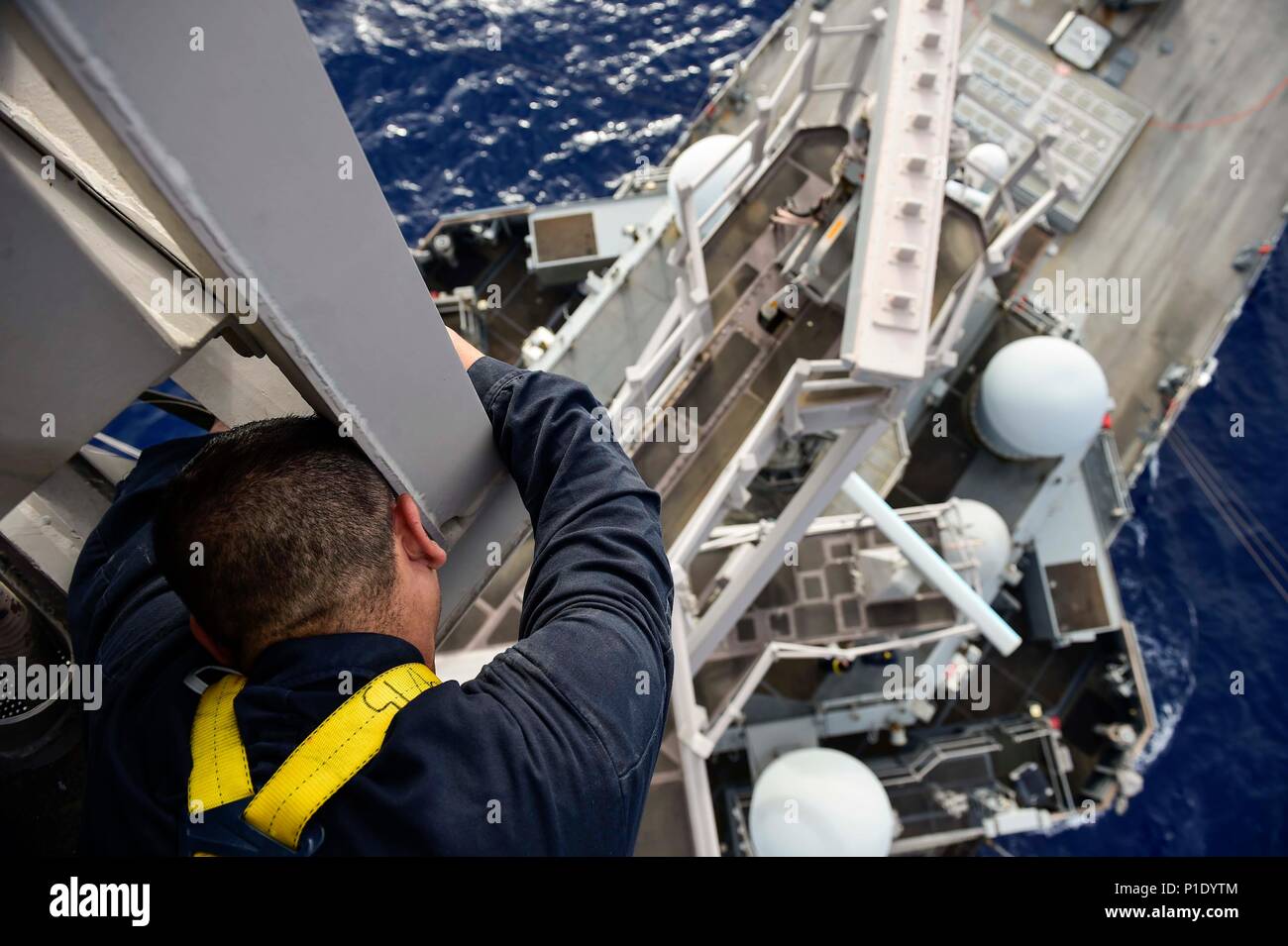 A sailor performs maintenance on the mast of USS Ross (DDG 71), an ...