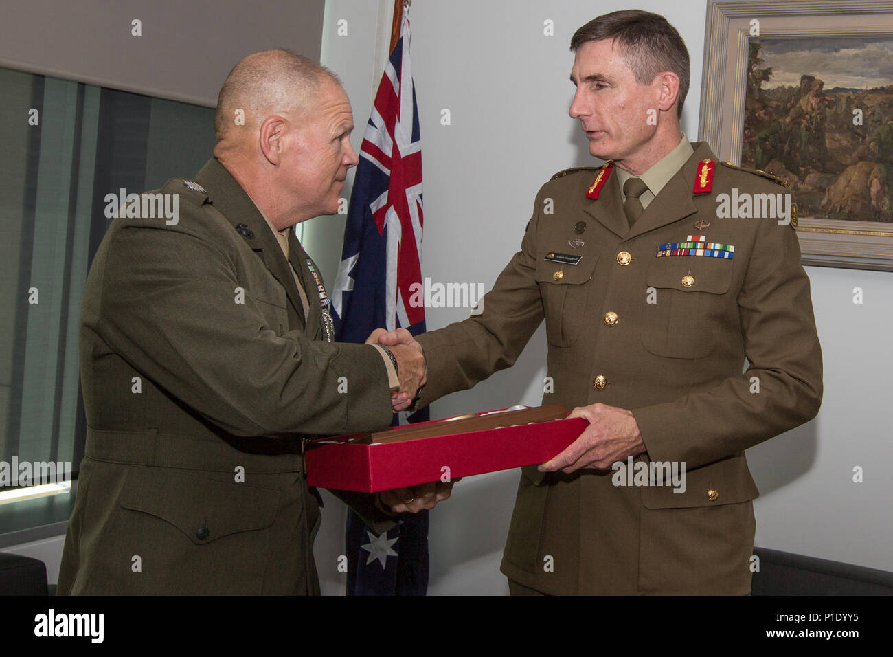 Commandant of the Marine Corps Gen. Robert B. Neller, left, presents a ...
