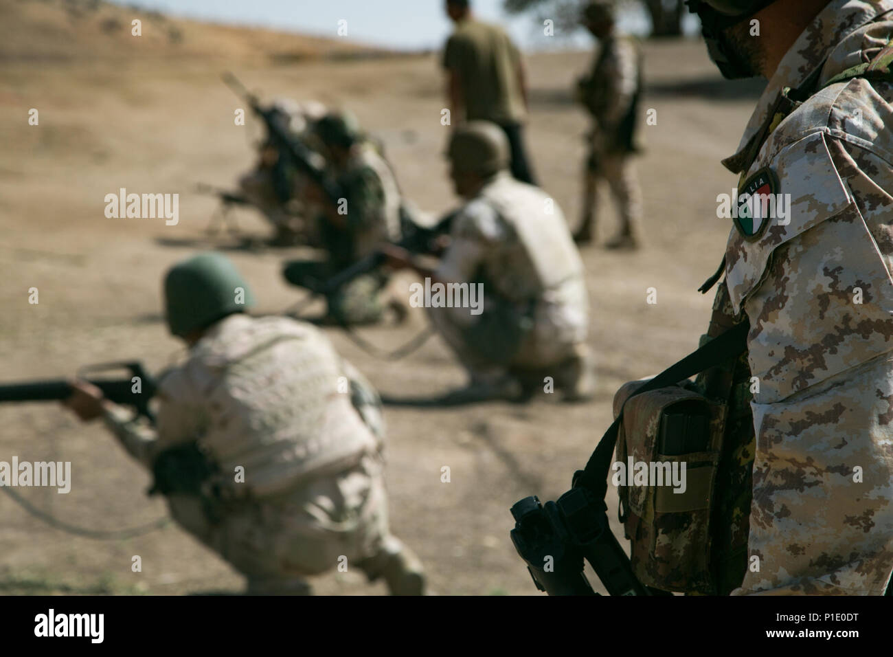Peshmerga soldiers prepare to assault an objective under the ...