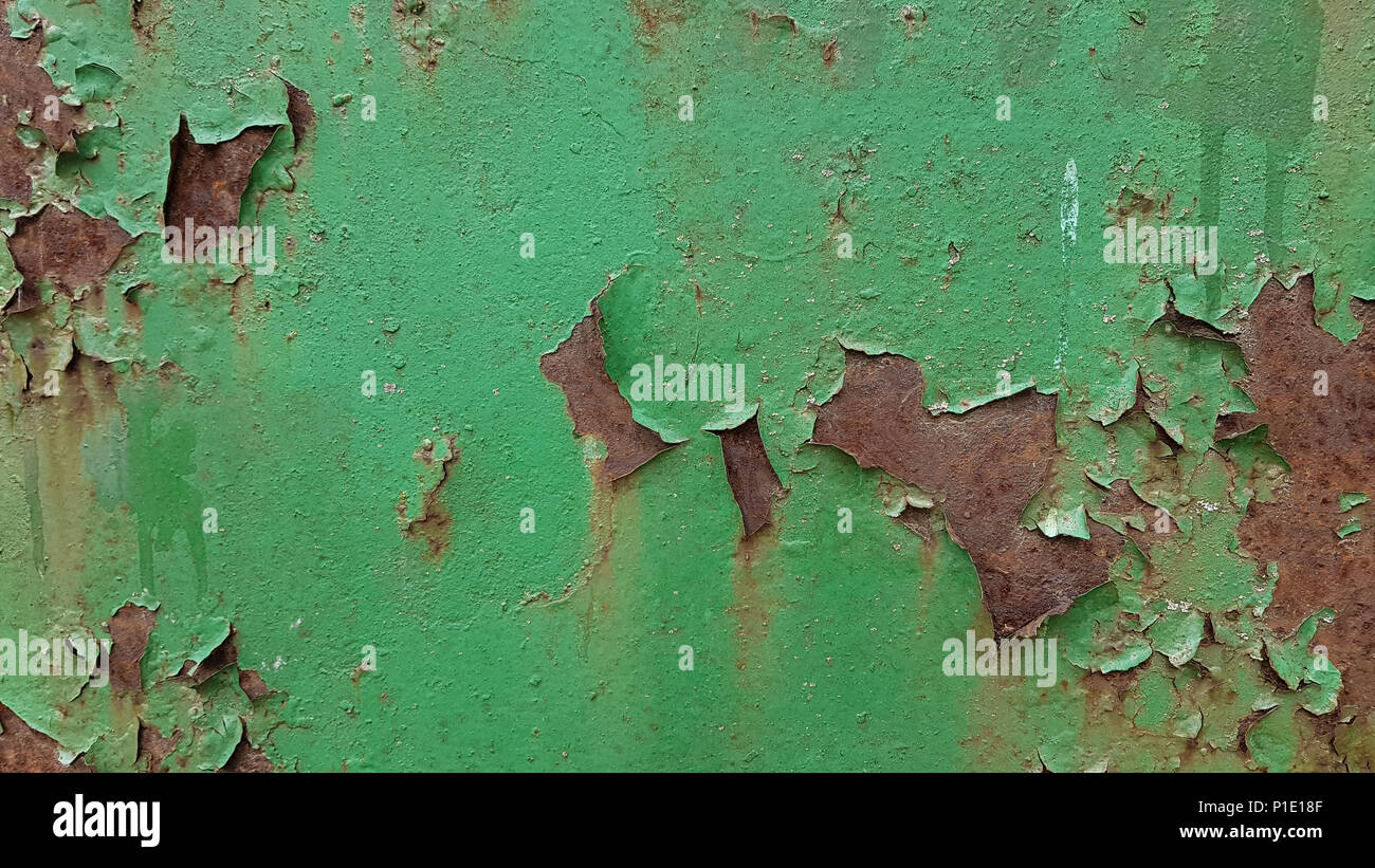 Abstract background of a metal wall green color with spots of brown ...